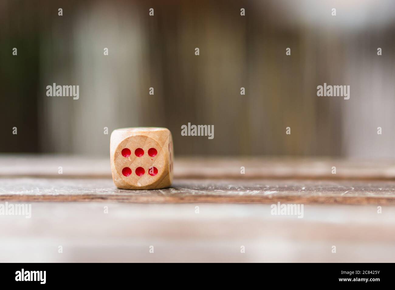 Selective focus shot of a wooden die with six red spots Stock Photo - Alamy