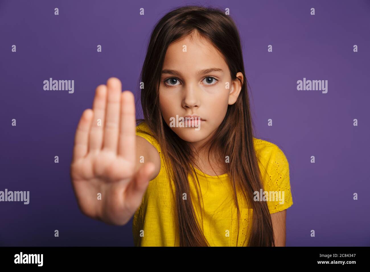 Photo of serious pretty girl showing stop gesture with hand on camera ...