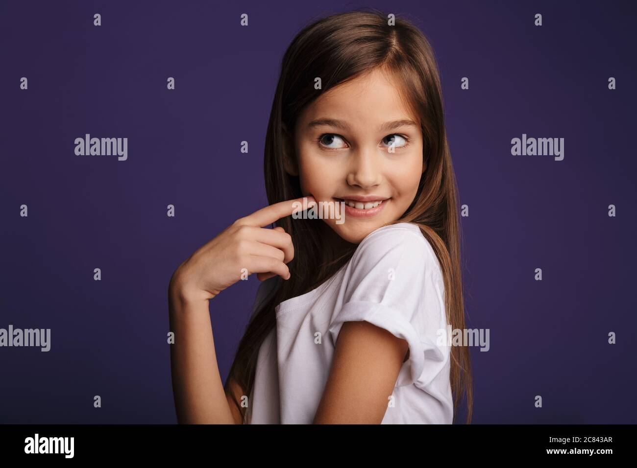 Photo of nice attractive girl smiling and pointing finger at her cheek ...