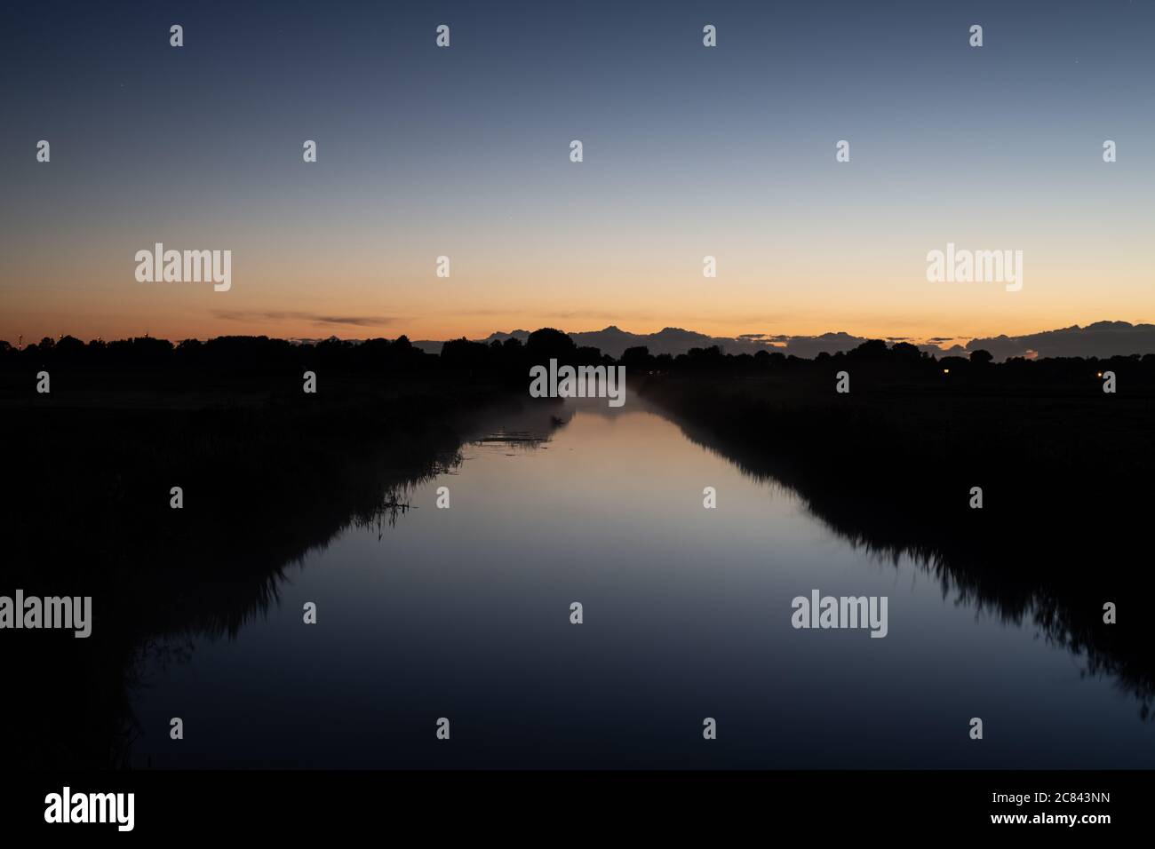 a river glows at night with the horizon along with dark landscape Stock ...