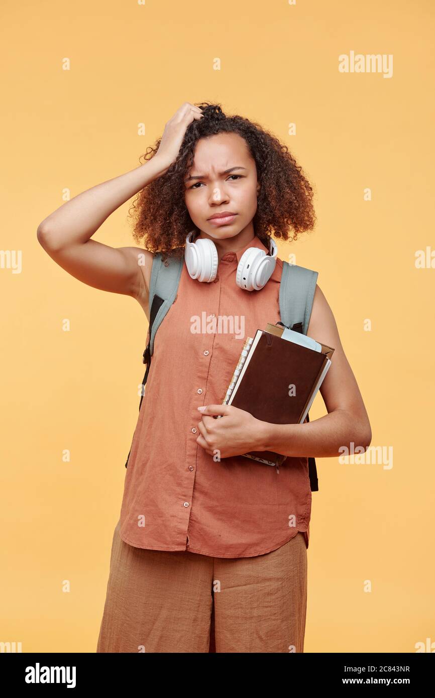 Portrait of puzzled frowning black student girl in casual outfit ...