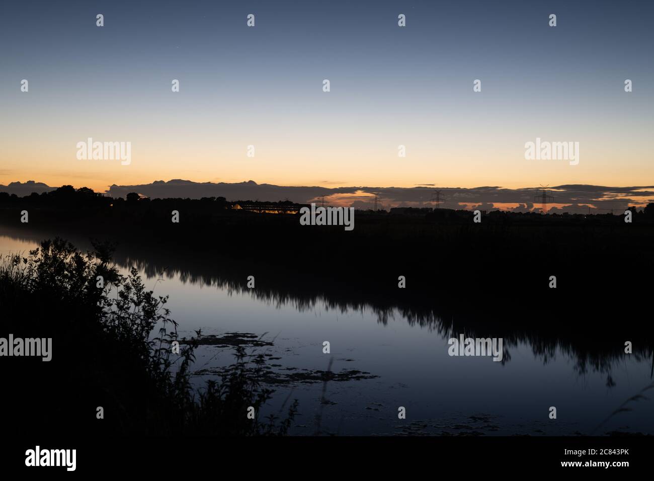 a river glows at night with the horizon along with dark landscape Stock ...