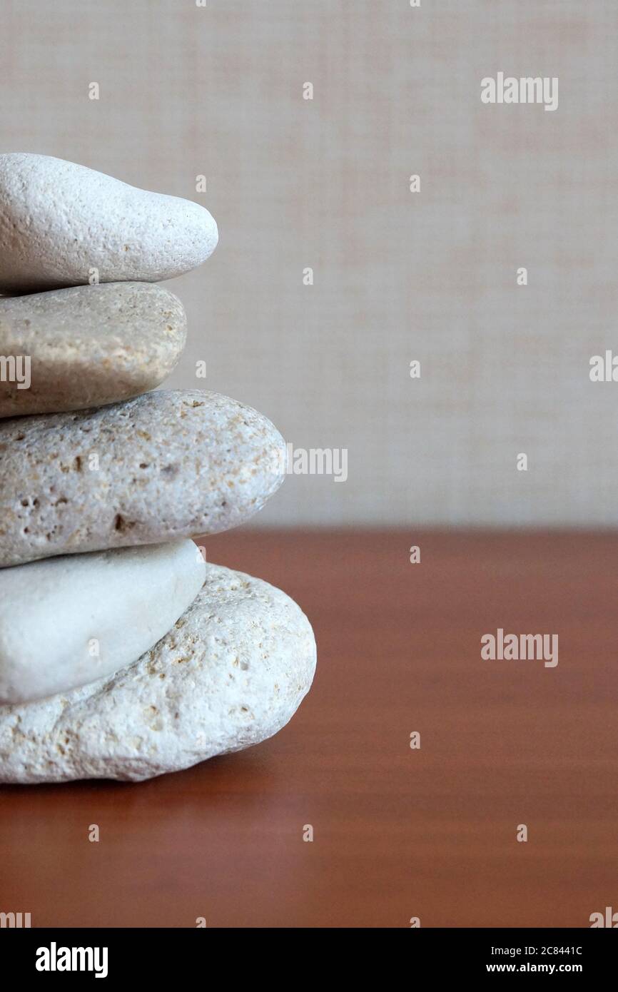 pyramid of round natural stones on a wooden background as a symbol of ...