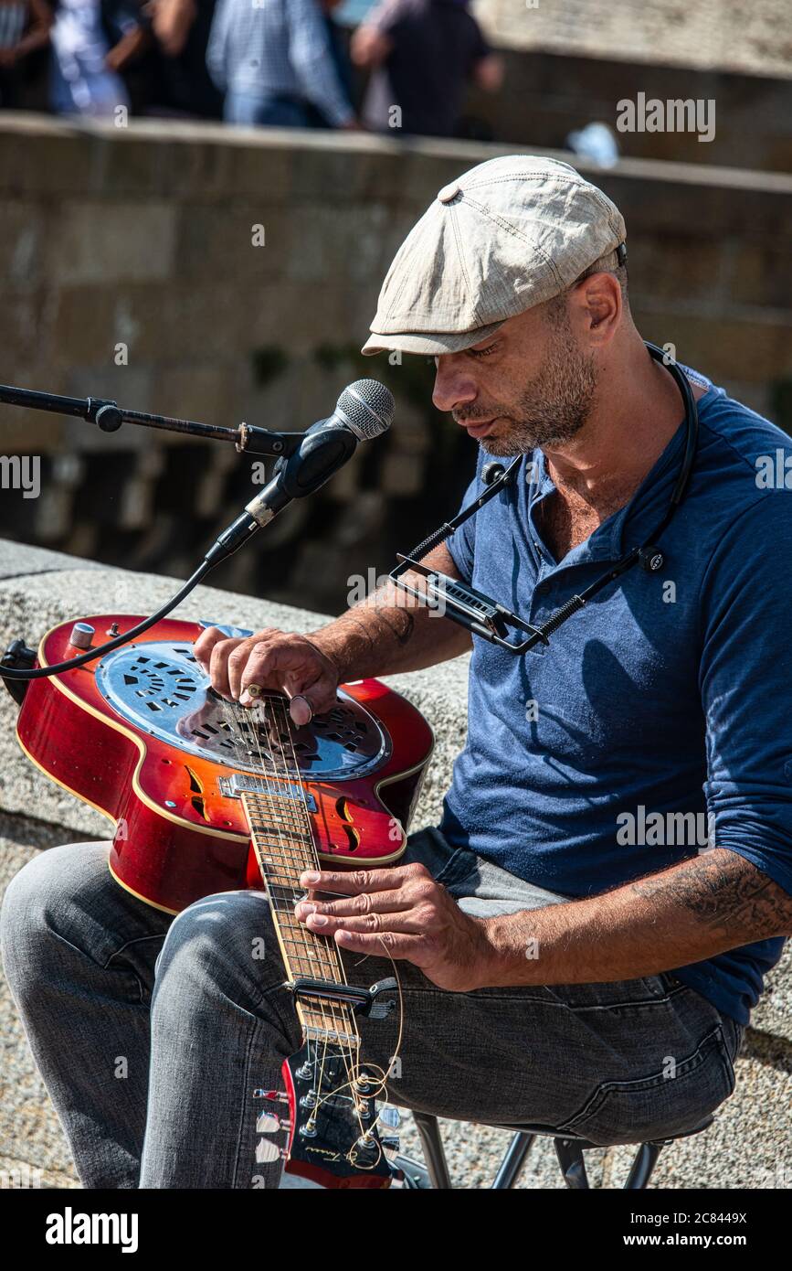 Man Playing Steel Guitar with Picks in the old town of Saint-Malo ...