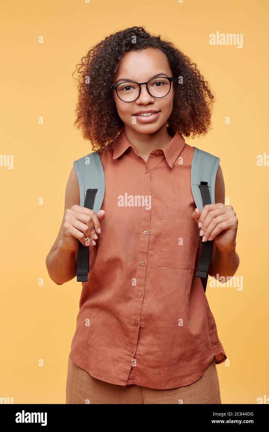 Portrait of smiling Afro-American high school student in eyeglasses ...