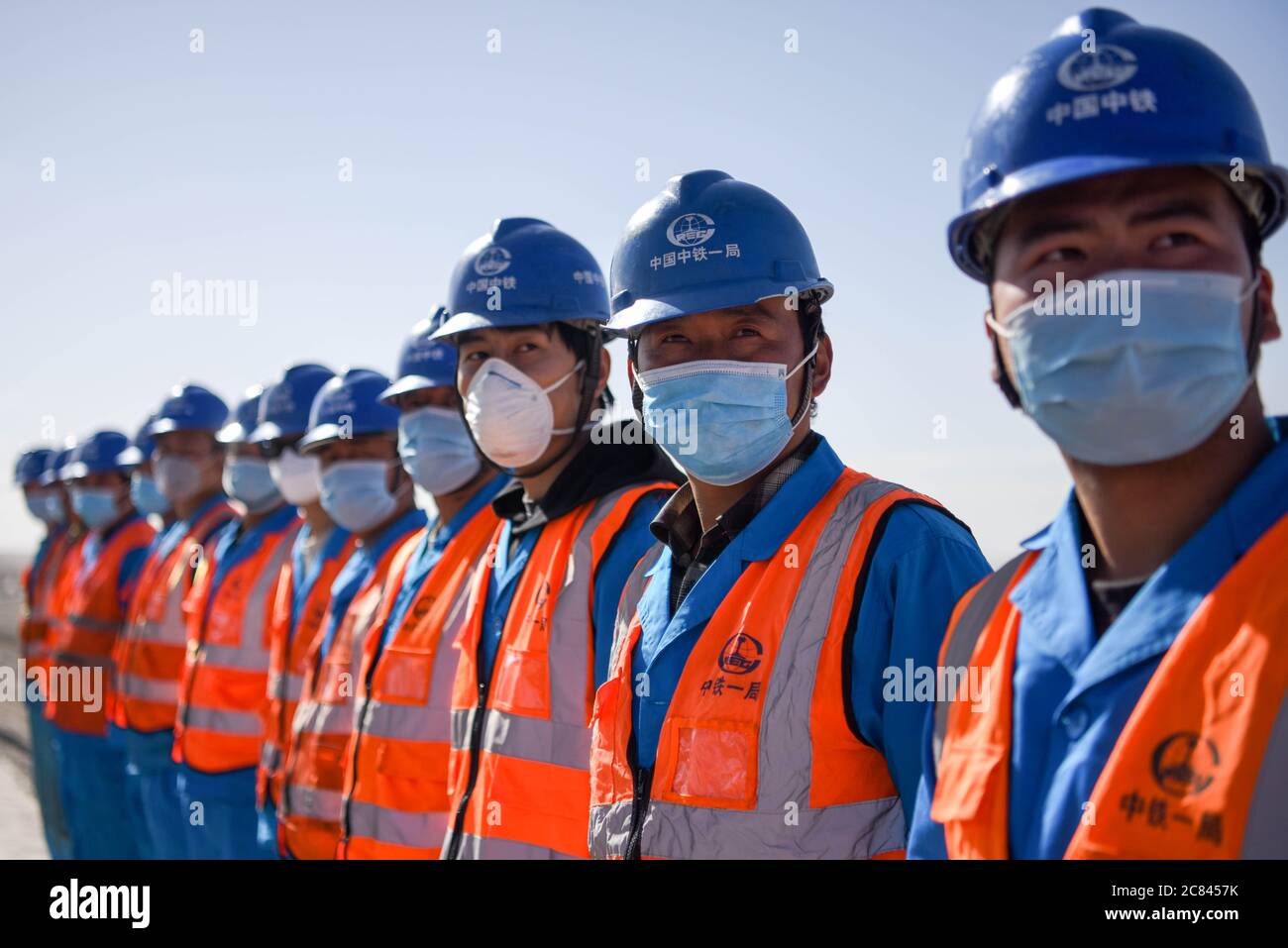 Ruoqiang, China. 21st July 2020. Workers witness the laying of the ...