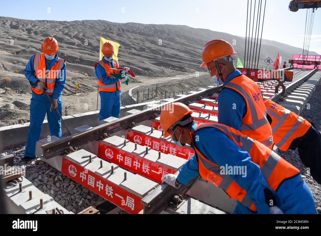 Ruoqiang, China. 21st July 2020. Workers lay the final tracks on the ...