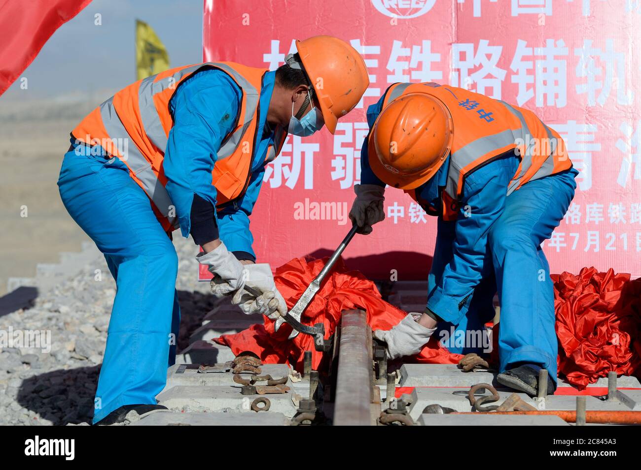 Ruoqiang, China. 21st July 2020. Workers lay the final tracks on the ...