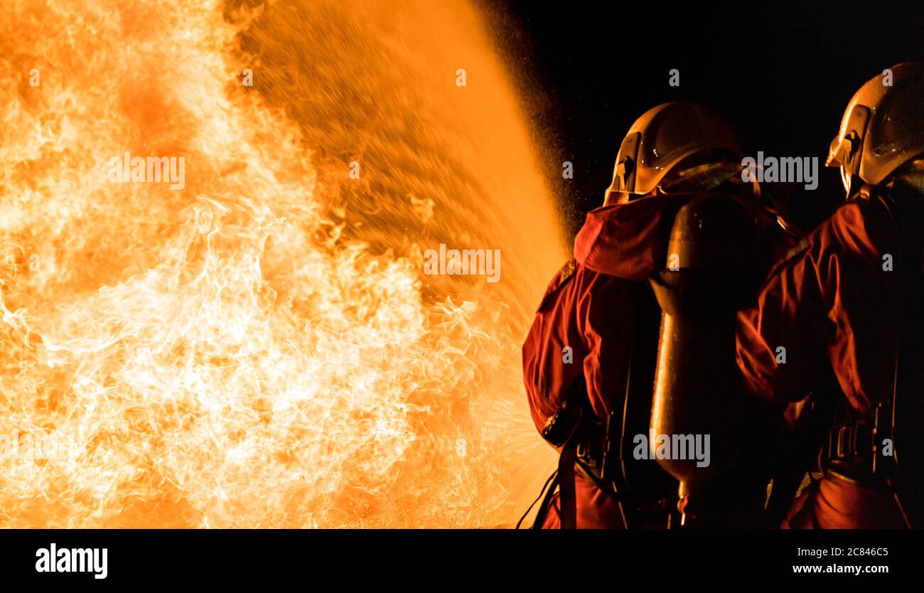 Firefighters using Twirl water fog type fire extinguisher to fighting ...