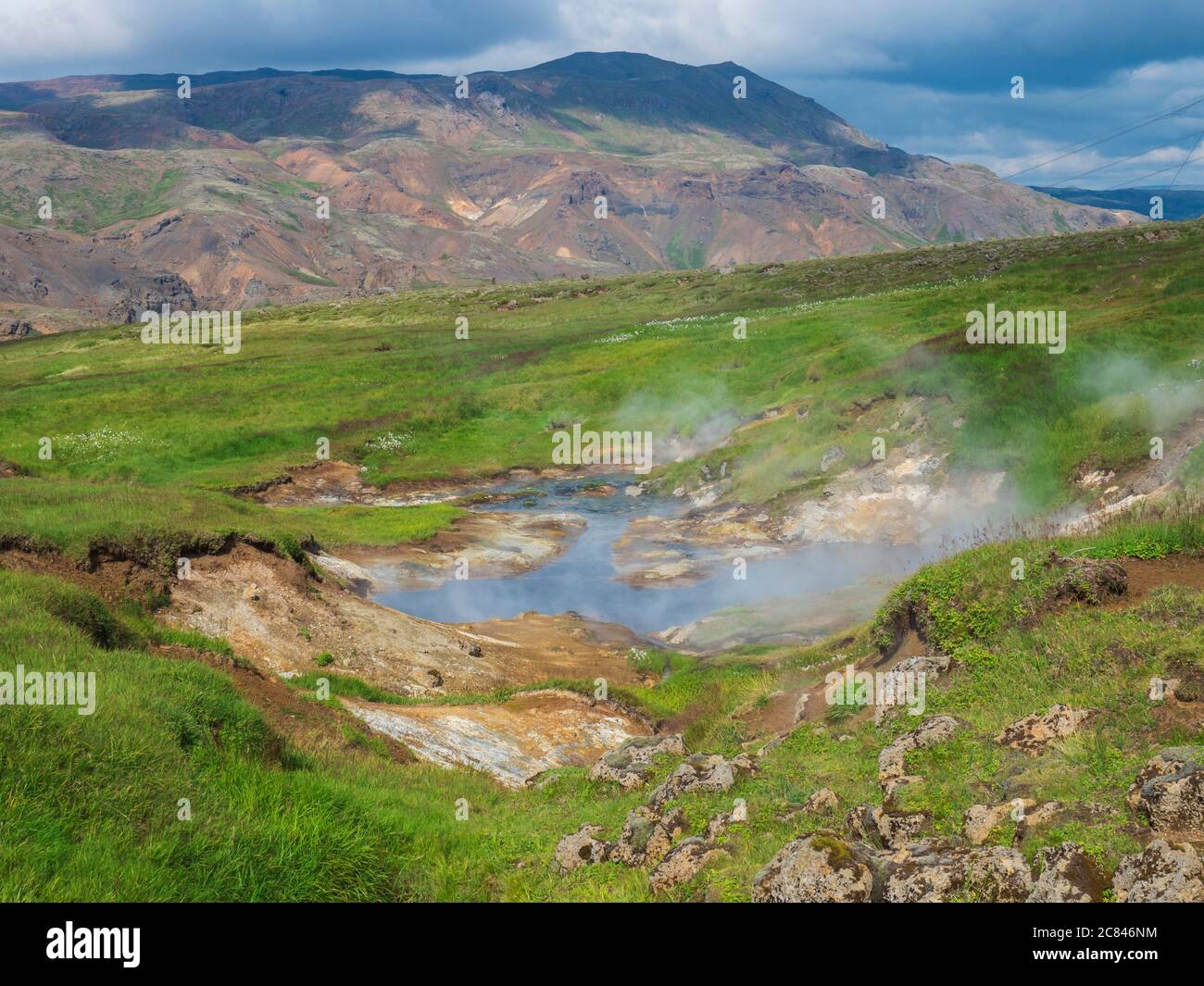 Reykjadalur valley with hot springs river and pool with lush green ...