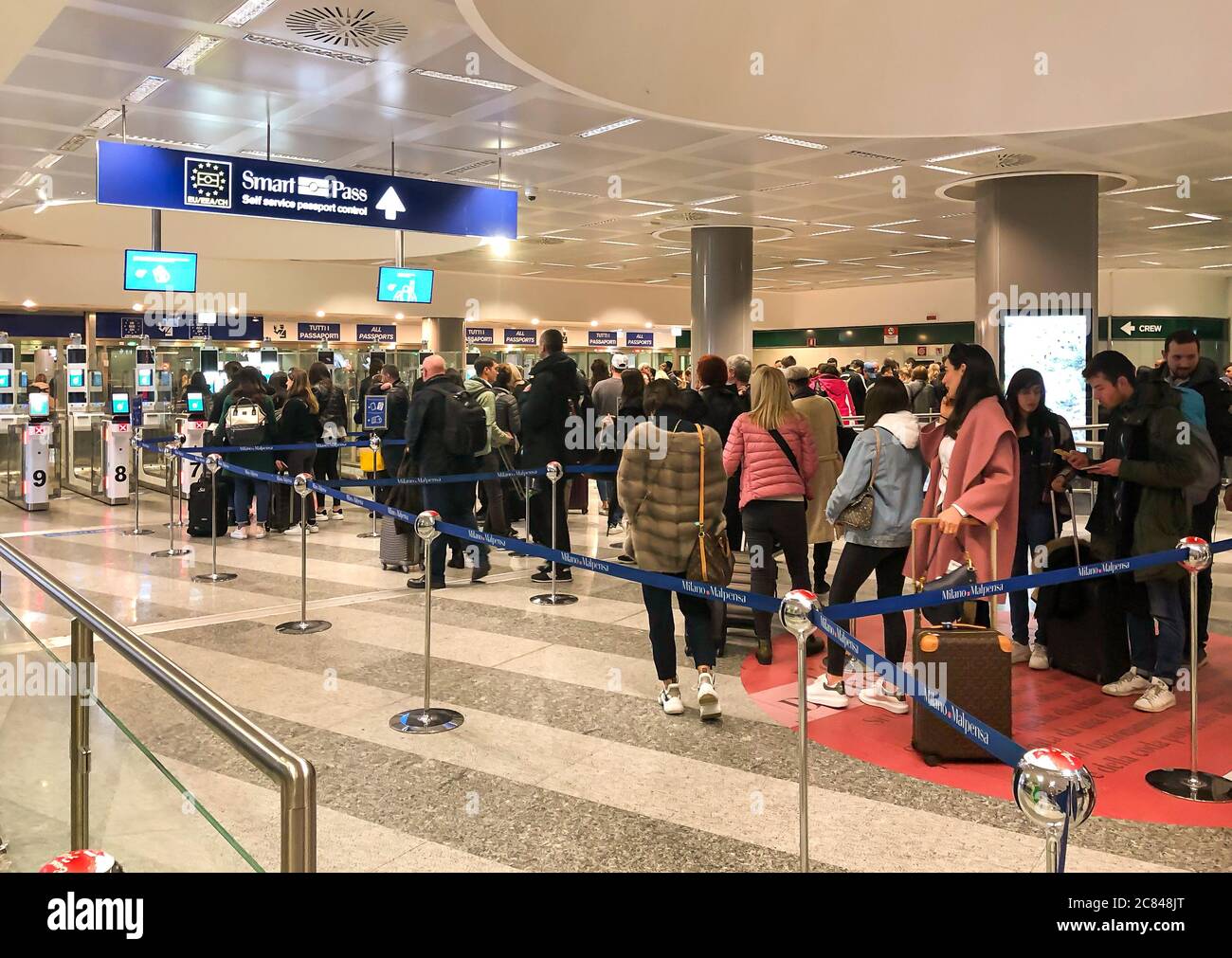 Ferno, Milan-Malpensa, Italy - February 16, 2020: Passengers wait for ...