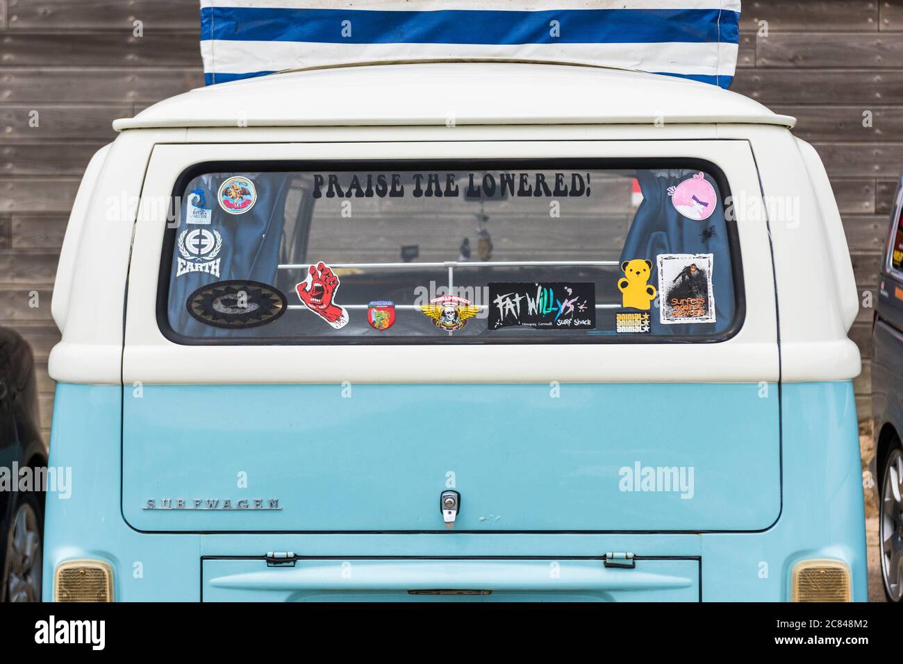 Various colourful stickers on the rear window of a Volkswagen Surfwagen ...