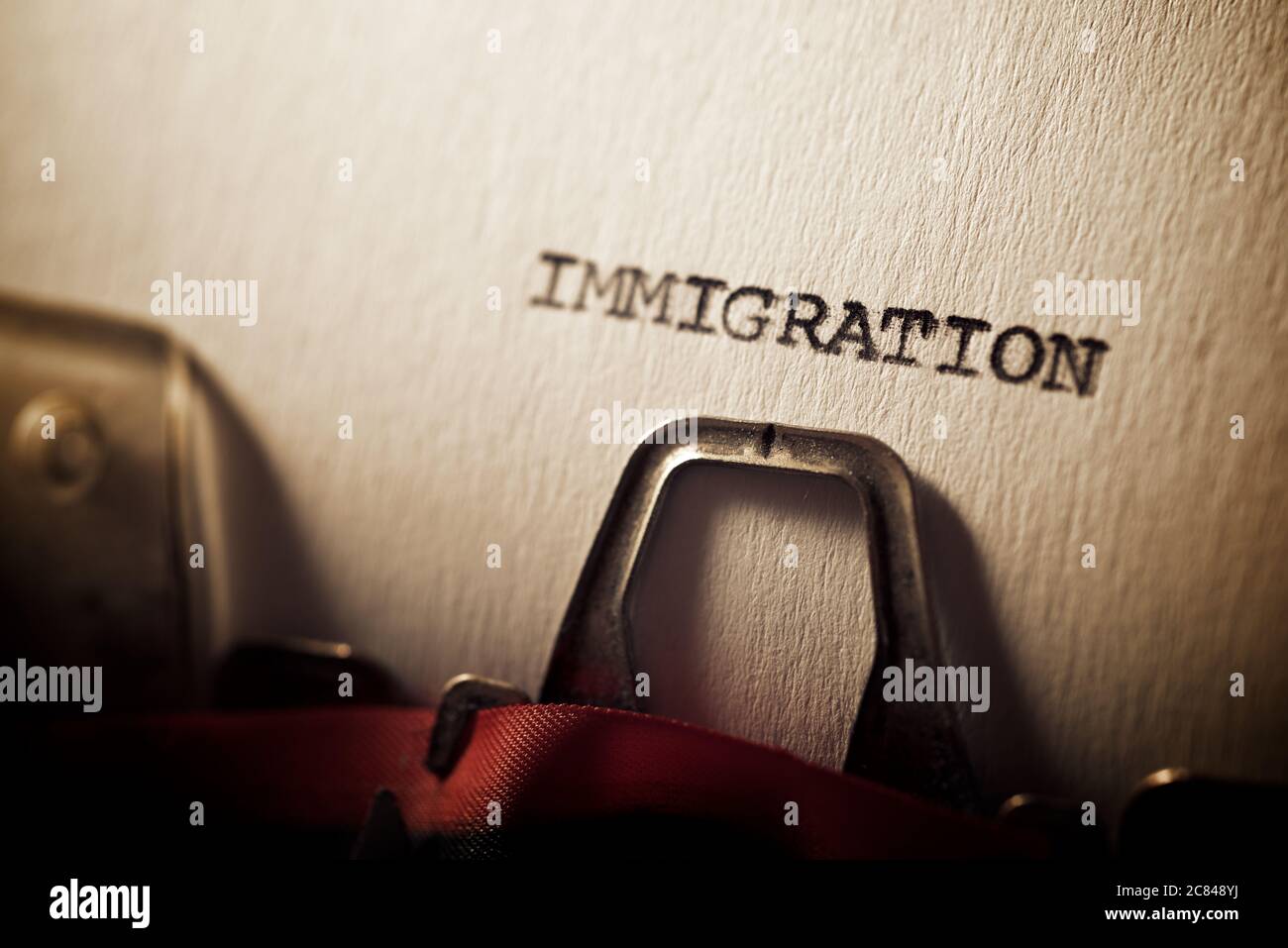 Immigration word written with a typewriter Stock Photo - Alamy