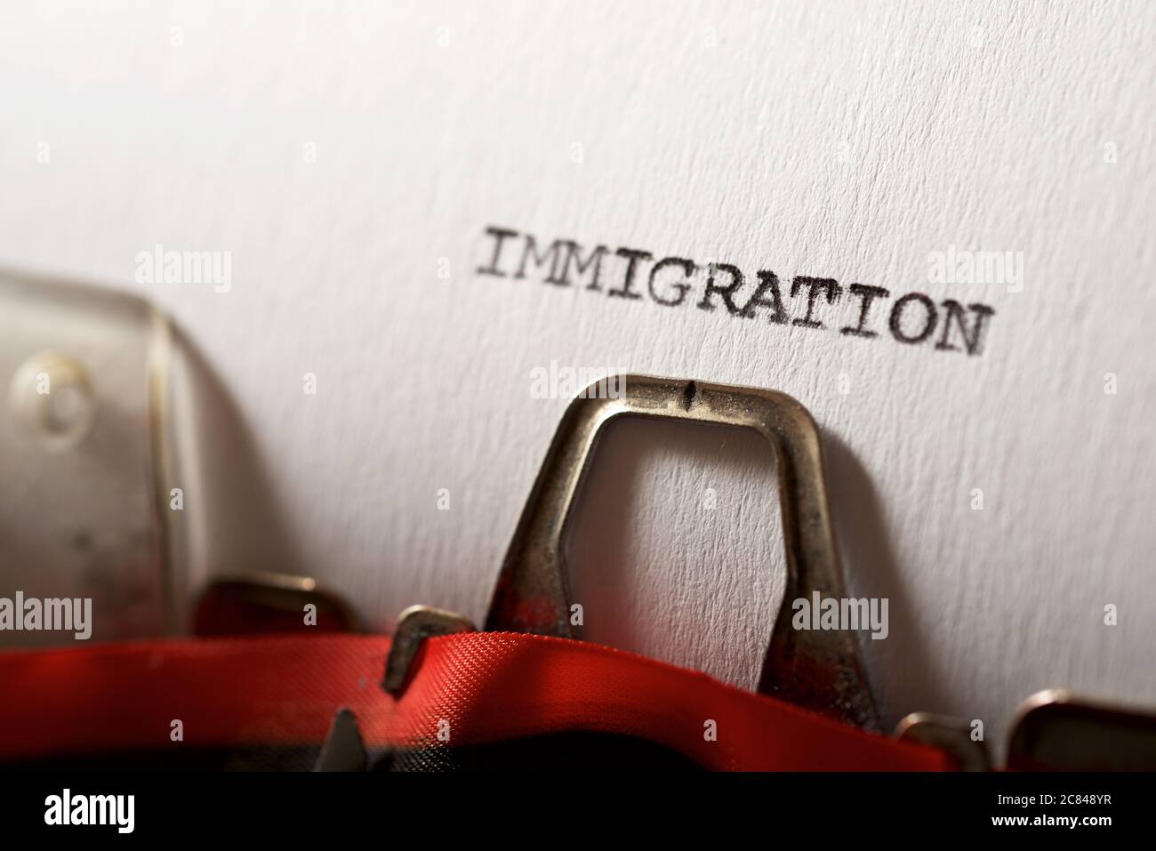 Immigration word written with a typewriter Stock Photo - Alamy