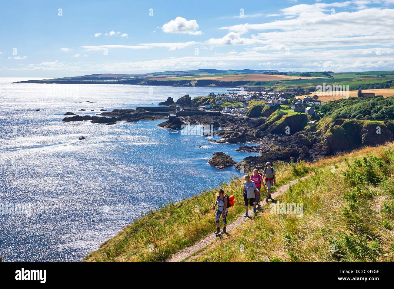 Four hikers walking on the coastal path at St. Abb's Head with the ...