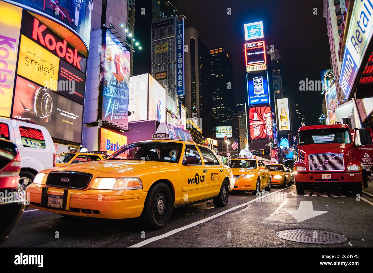 Low angle shot of New York city yellow taxi cab on busy Times Square ...