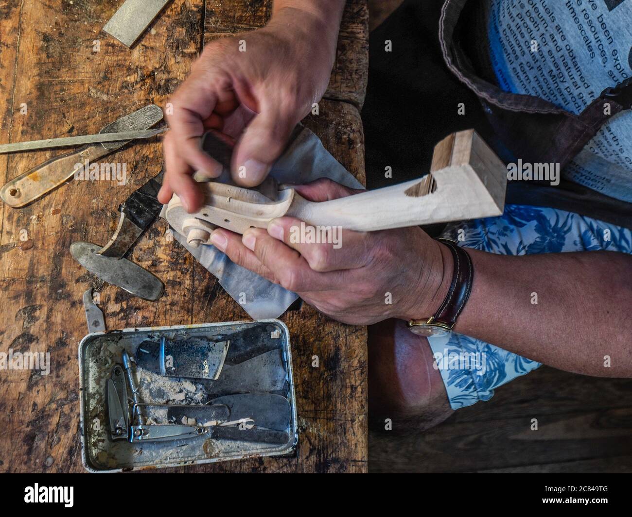 Hands of luthier violin maker carving and working on a instrument ...