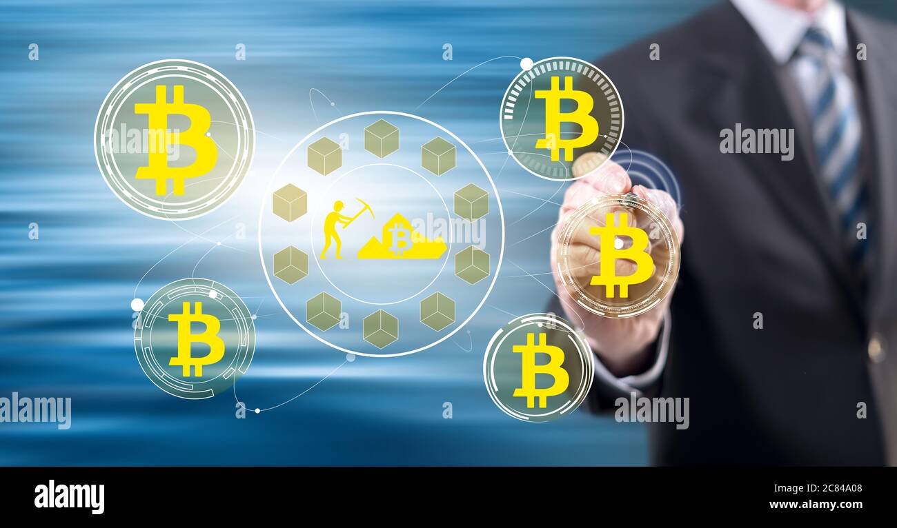 Man touching a bitcoin mining concept on a touch screen with a stylus ...