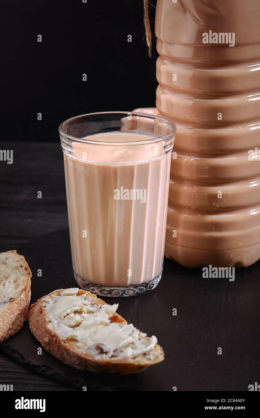 Homemade fermented baked milk in transparent bowl on an old dark ...