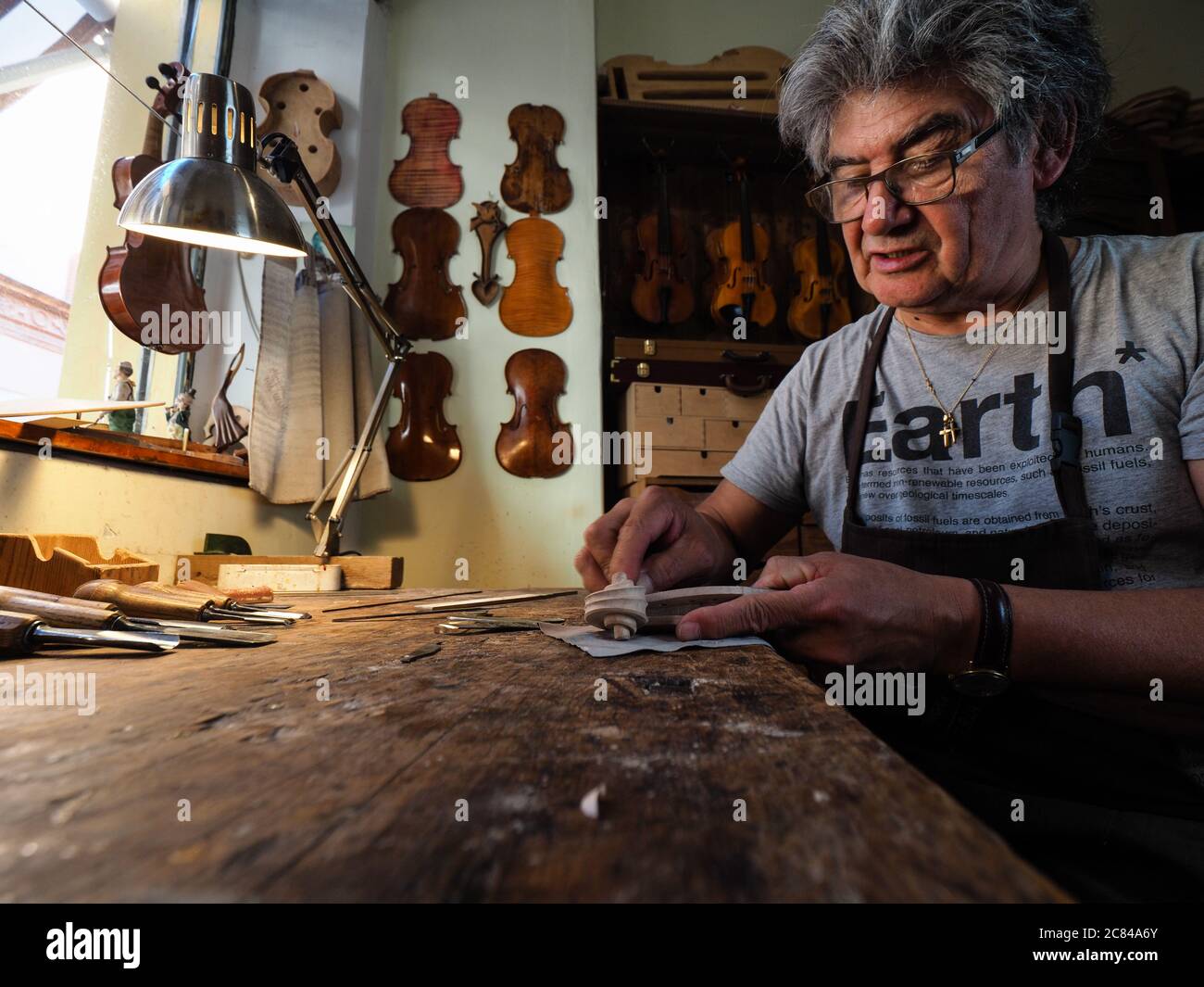 Luthier violin maker Carlos Roberts working in his workshop in Cremona ...