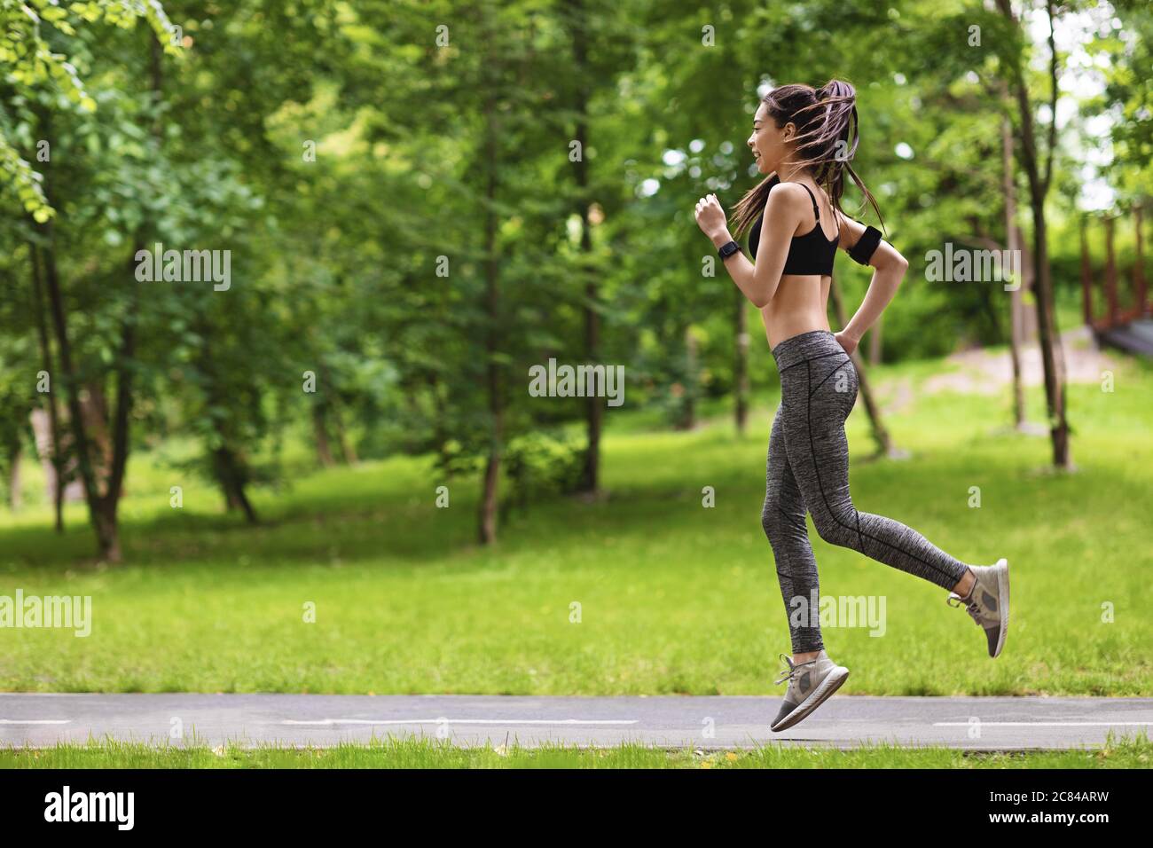 Jogging Concept. Sporty Asian Woman Running On Path In Park, Side View ...