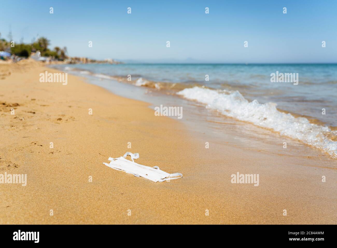 Beach polluted with face mask of covid. Environmental contamination ...
