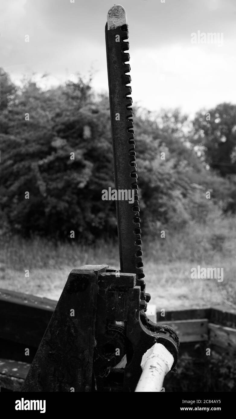 Monochrome image of the raised toothed paddle of a lock gate mechanism ...