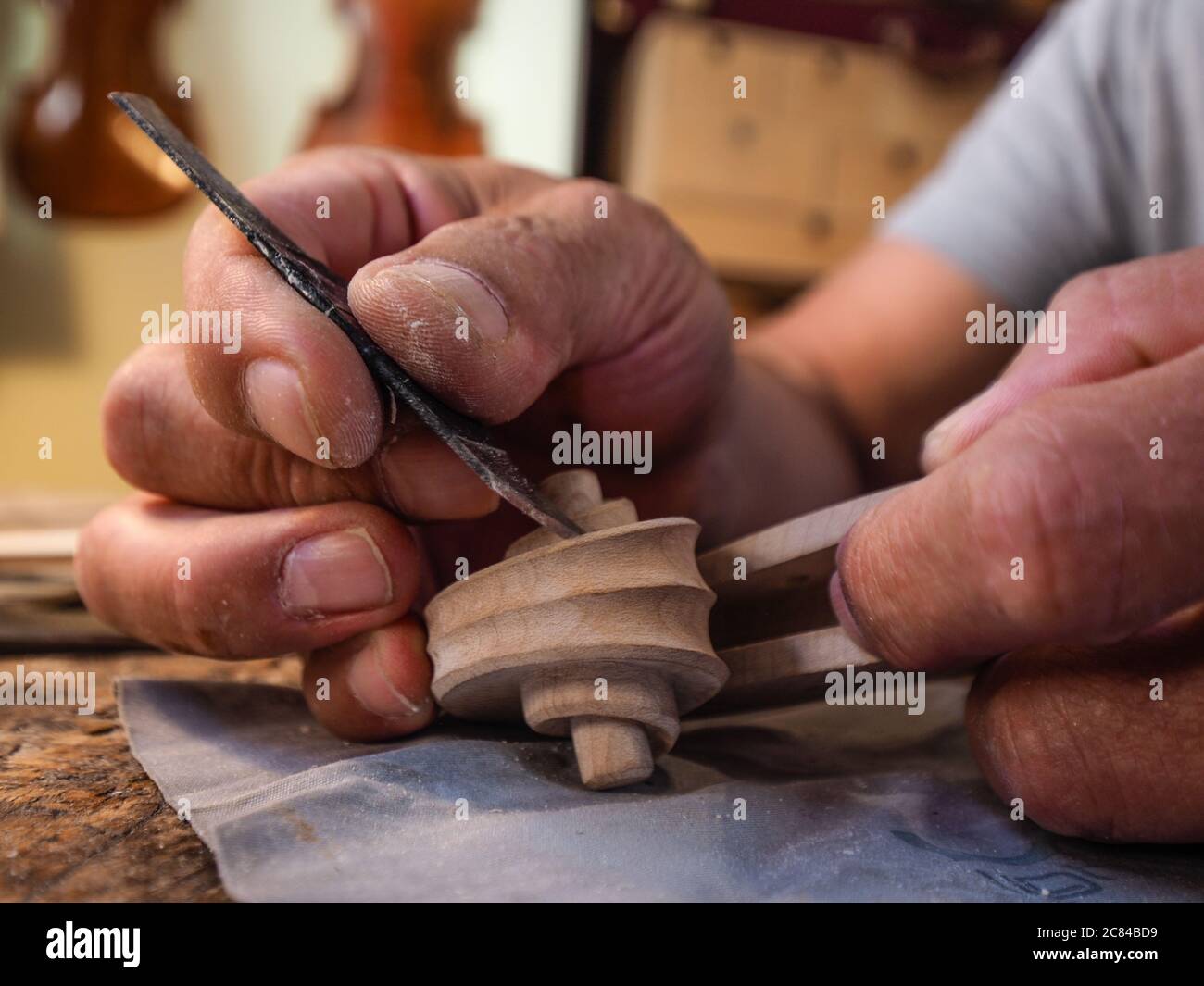 Hands of luthier violin maker carving and working on a instrument ...