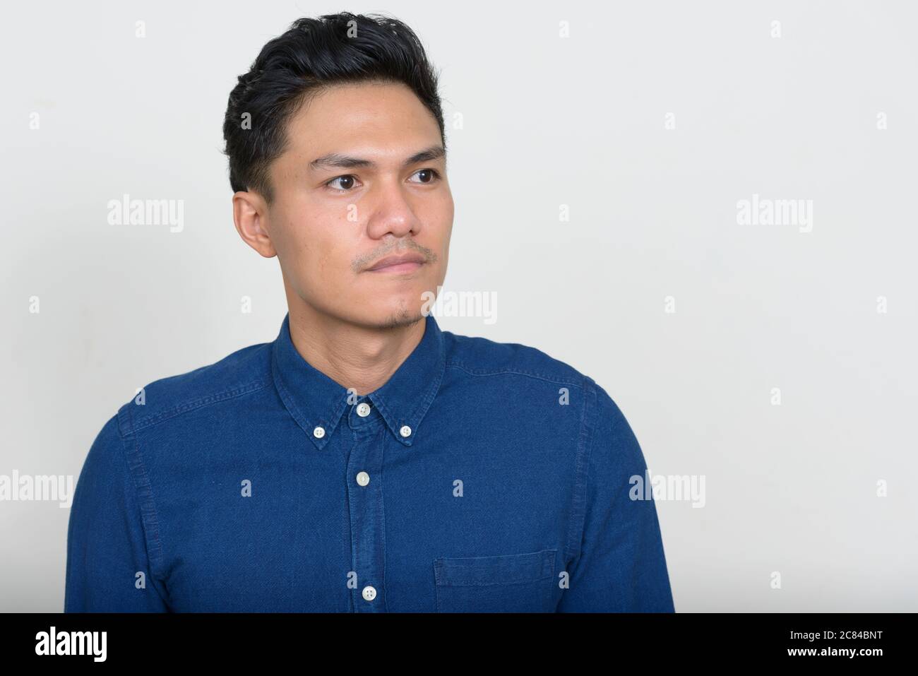 Portrait of handsome Asian businessman thinking and looking up Stock Photo - Alamy