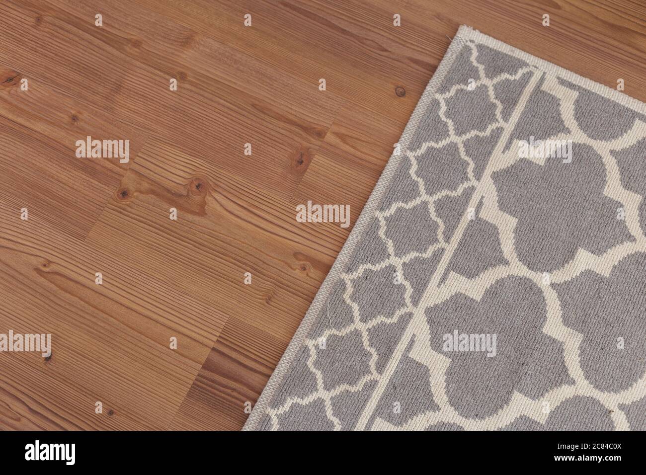 Close-up carpet on laminate wood floor in living room, interior ...