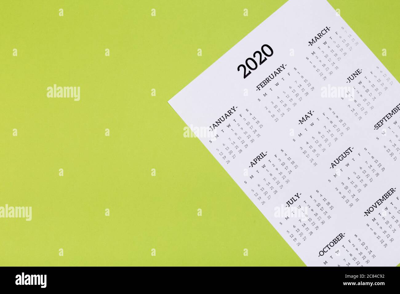 Open calendar on the table with green background, planning a business ...