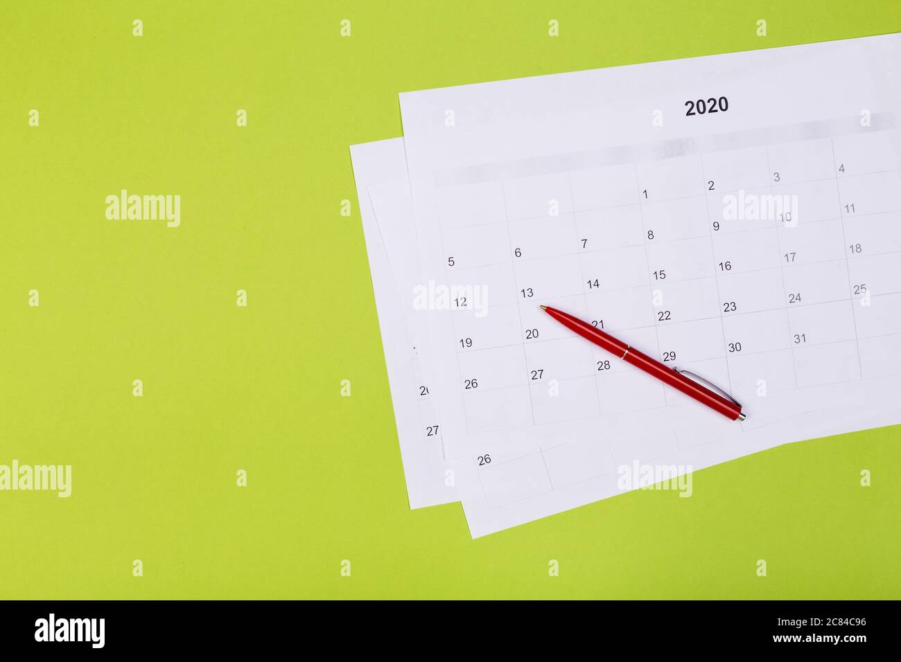 Open calendar on the table with green background, planning a business ...