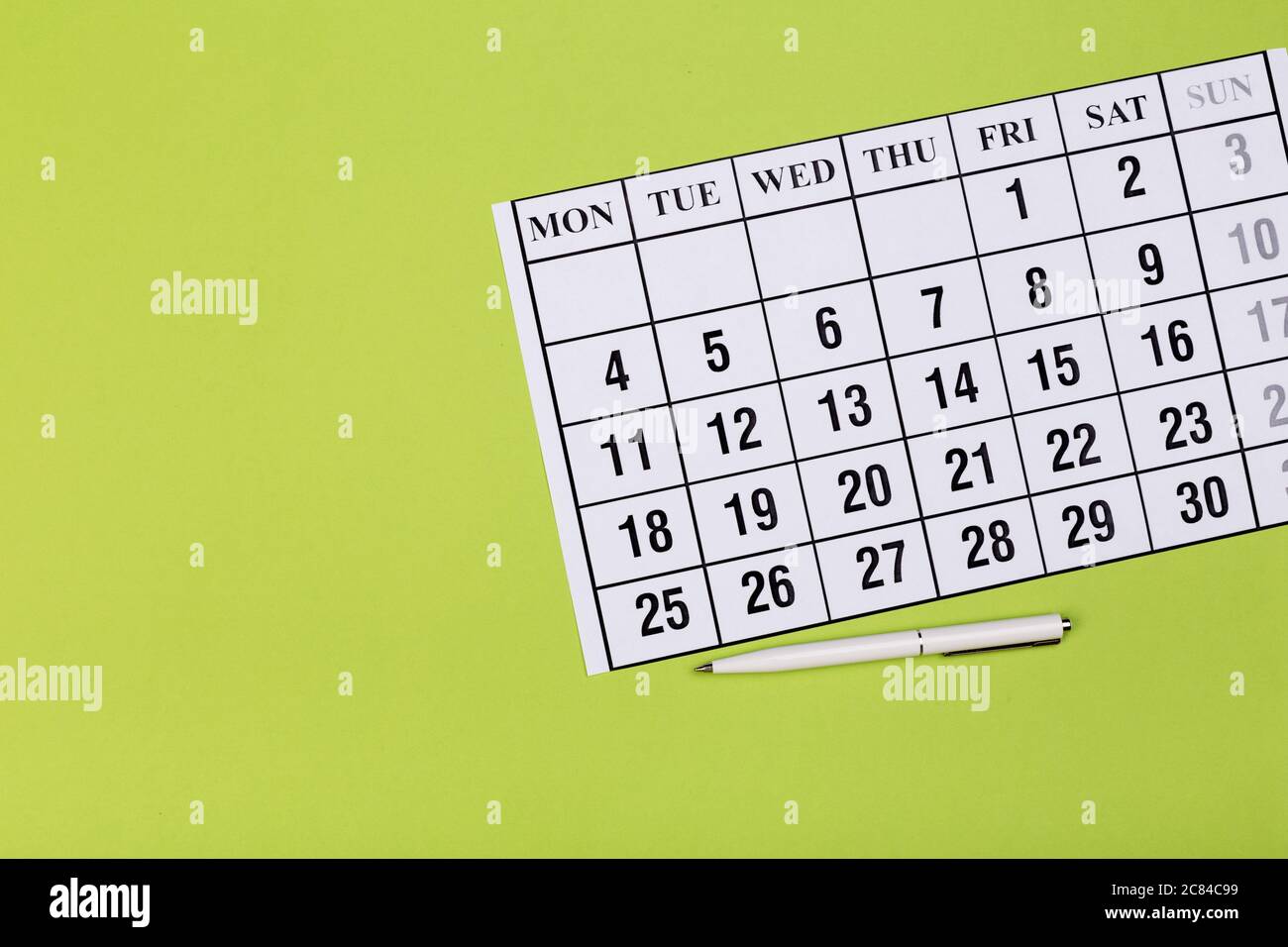 Open calendar on the table with green background, planning a business ...