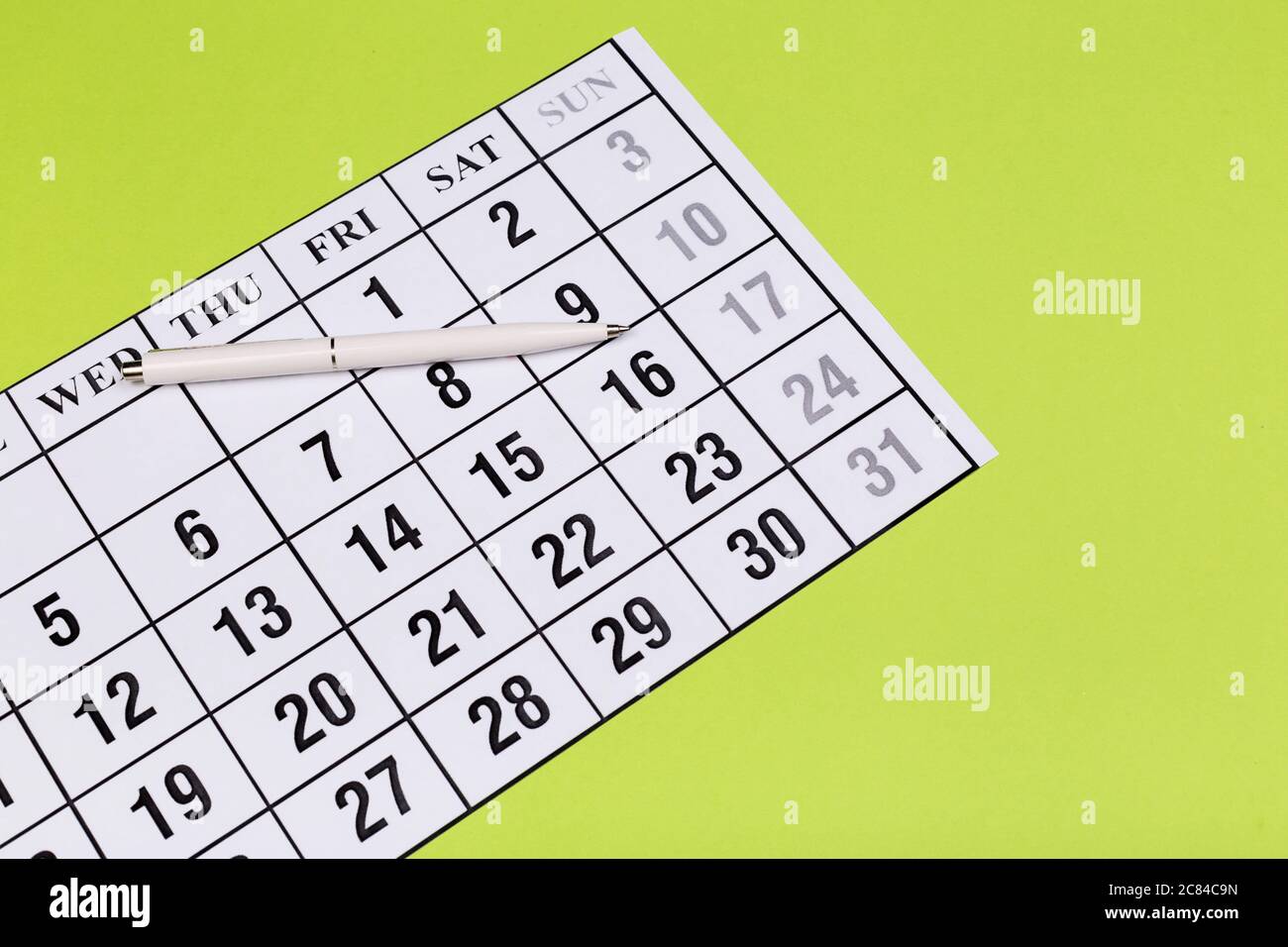 Open calendar on the table with green background, planning a business ...