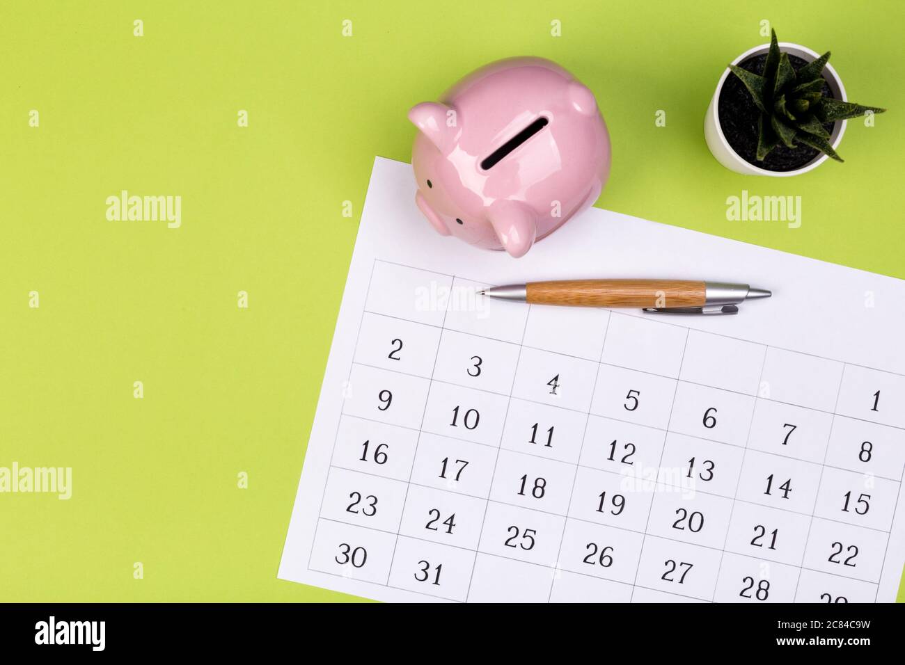 Open calendar on the table with green background, planning a business ...