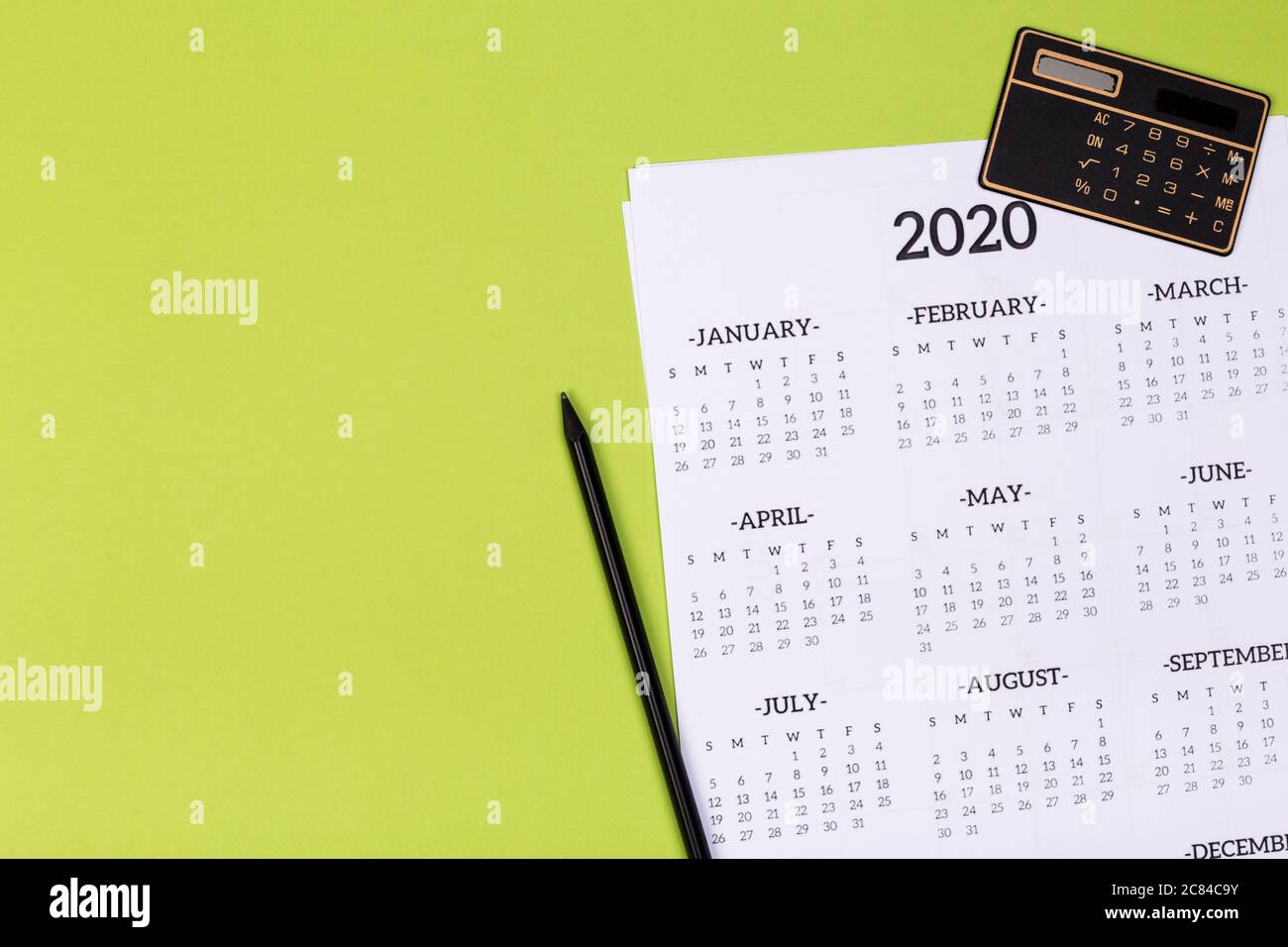 Open calendar on the table with green background, planning a business ...