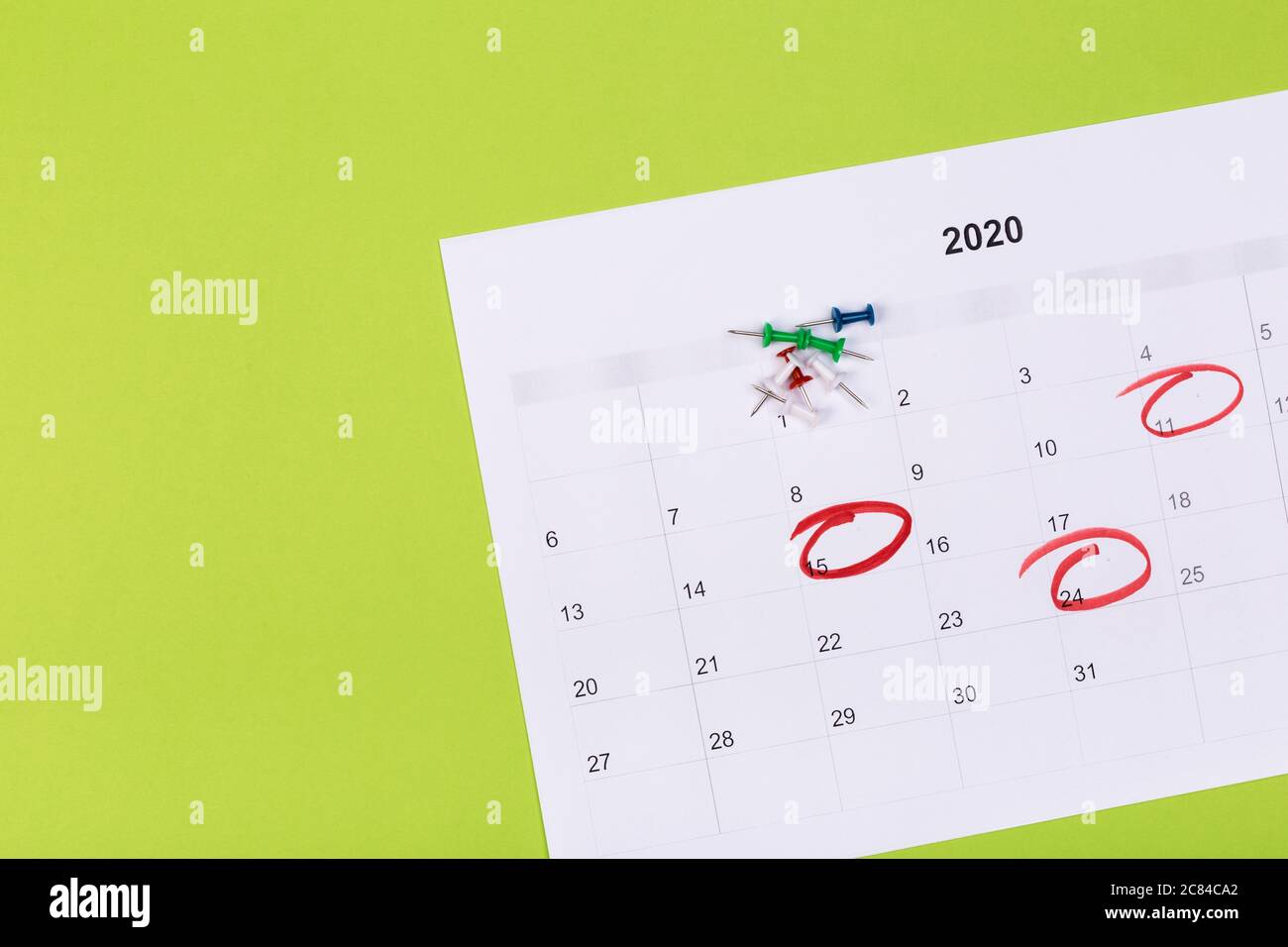Open calendar on the table with green background, planning a business ...