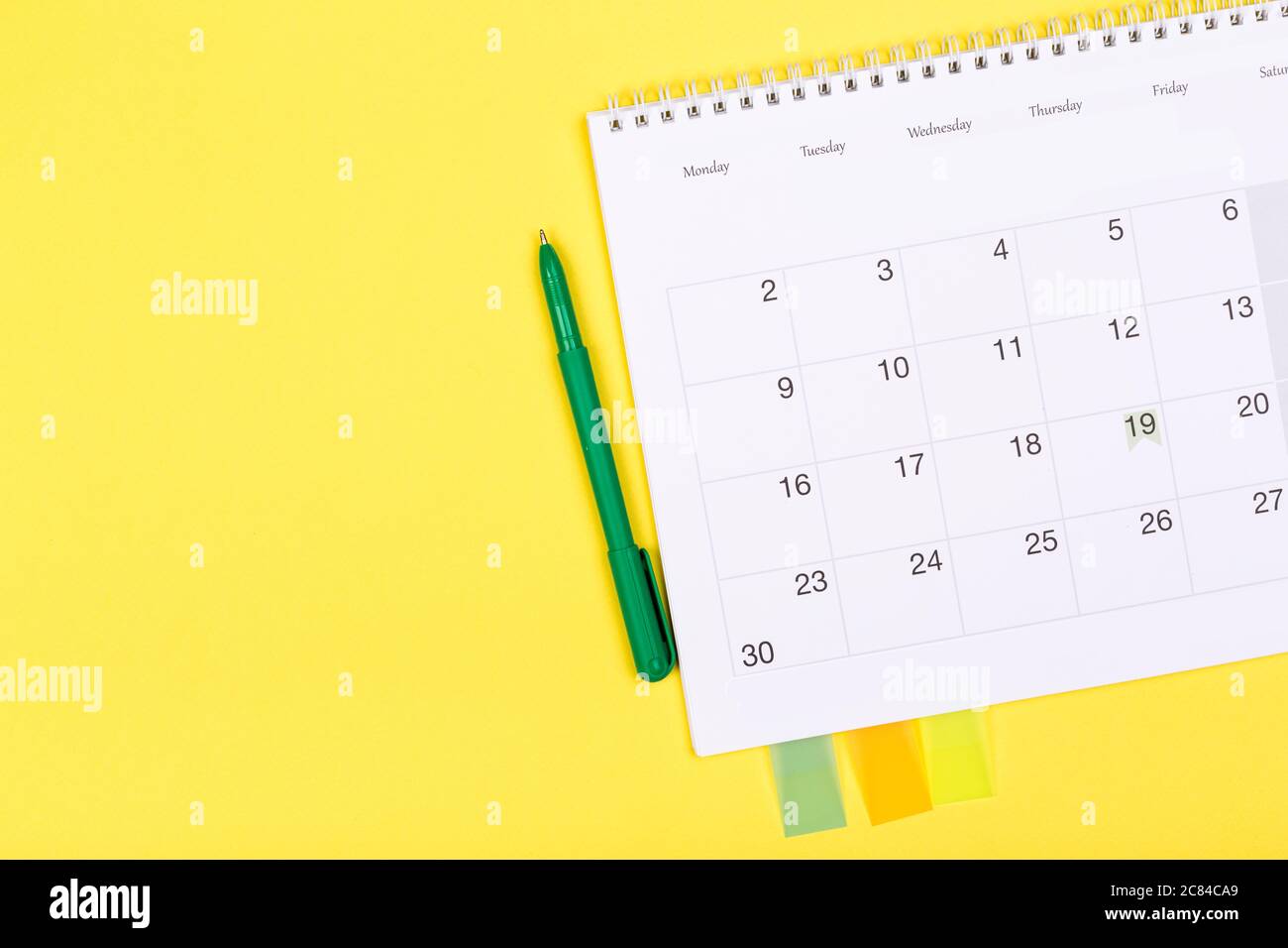 White clean calendar on solid yellow background with copy space ...
