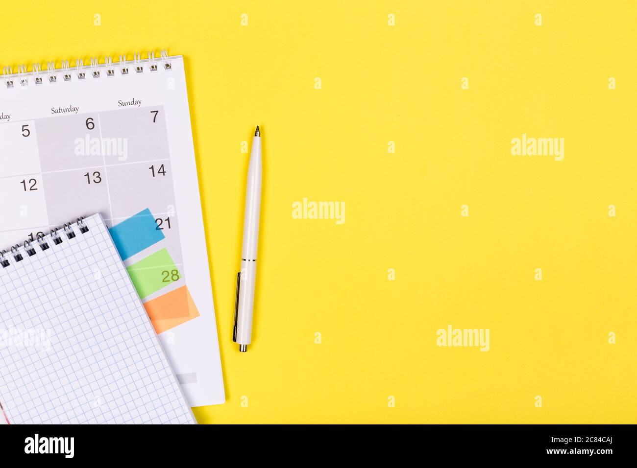 White clean calendar on solid yellow background with copy space ...