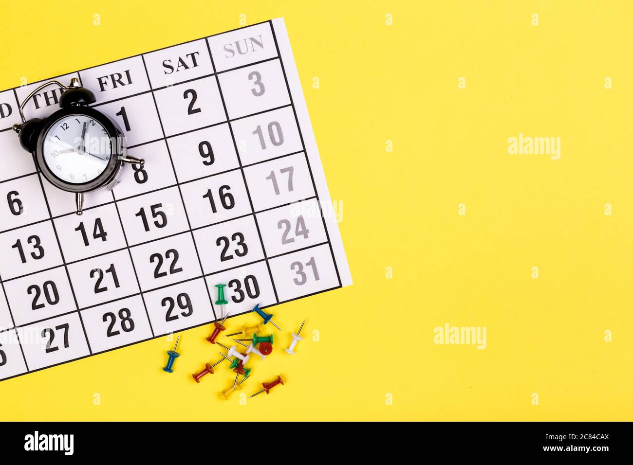 White clean calendar on solid yellow background with copy space ...