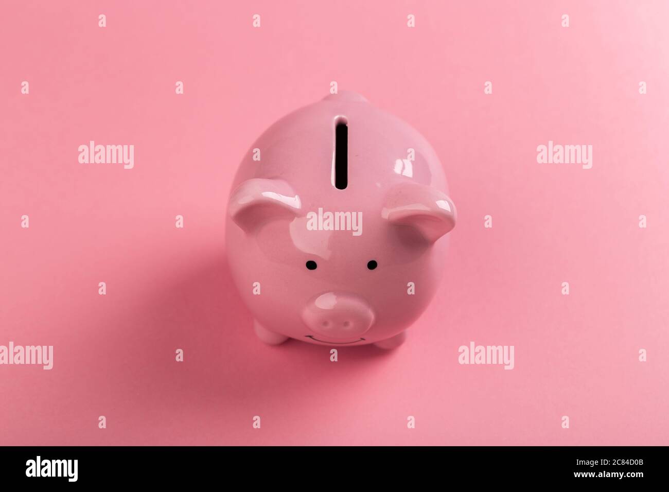 beautiful pink piggy bank on rose background. The concept of saving ...