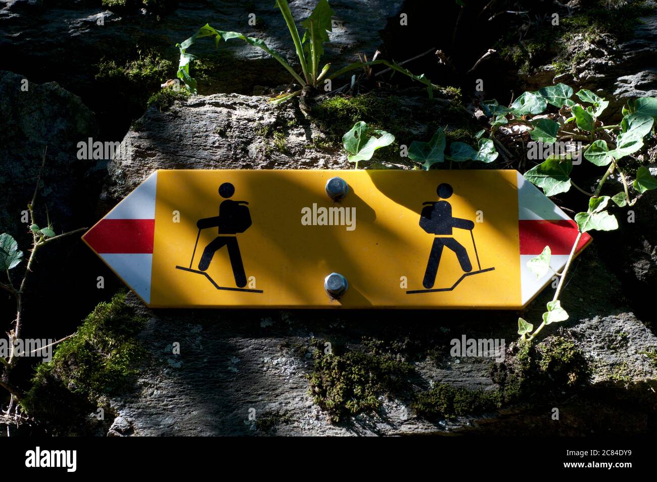 Close up of a Swiss hiking trail direction sign illuminated by the sun ...