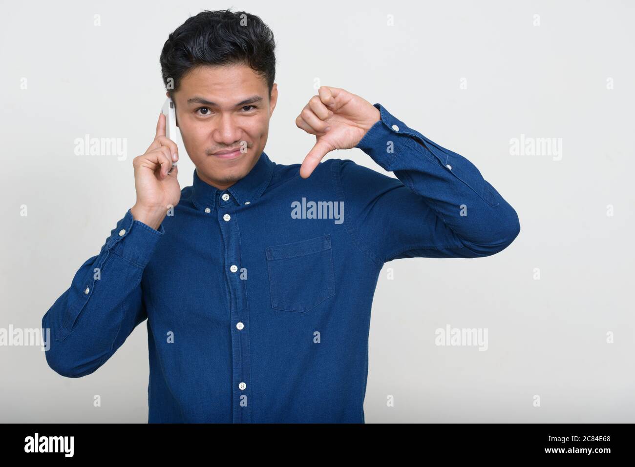 Stressed businessman giving thumbs down hi-res stock photography and ...