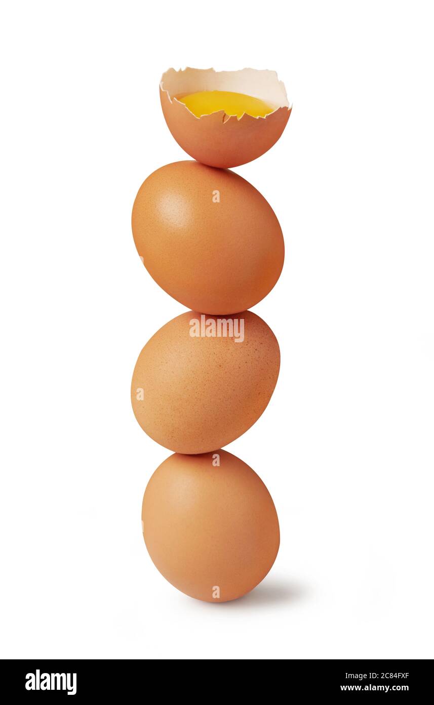 Eggs stack in balance white background Stock Photo - Alamy