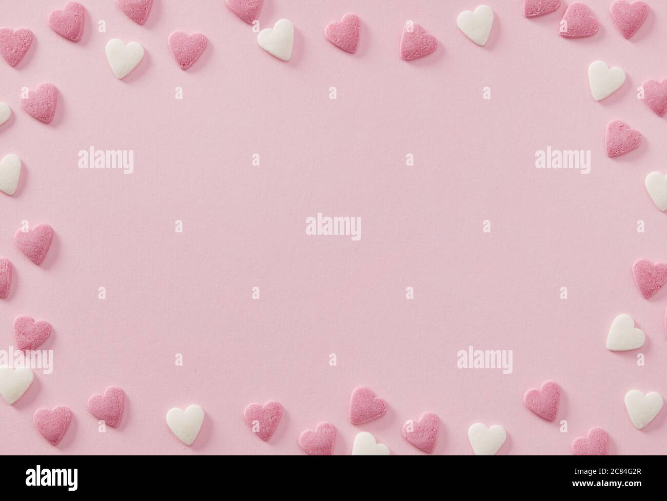 Hearth shaped candies frame Stock Photo - Alamy