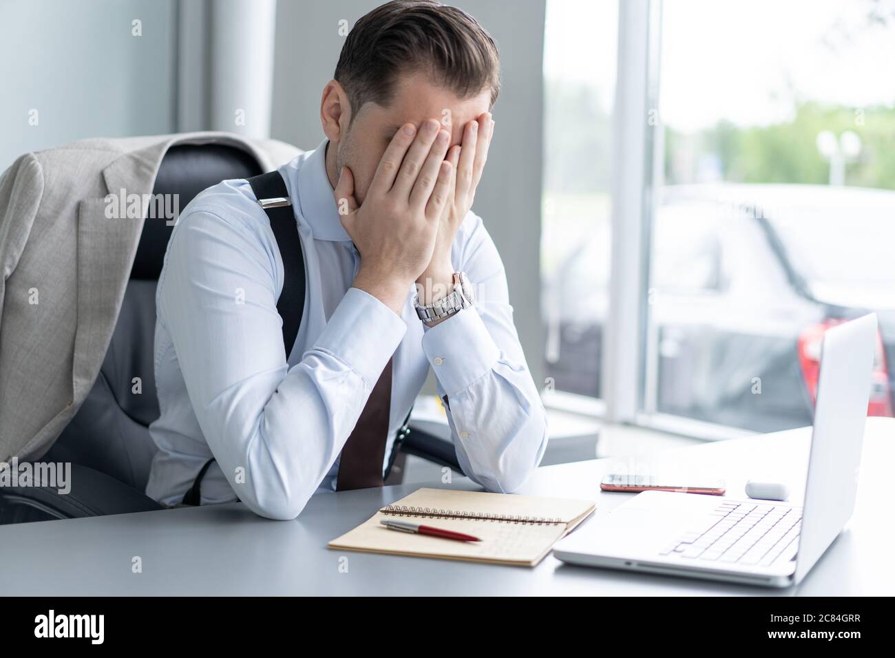 Feeling tired. Frustrated young handsome man looking exhausted while ...