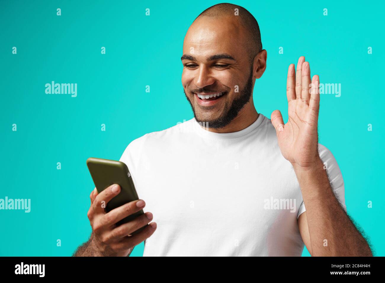 Young african american man making video call with his smartphone Stock ...
