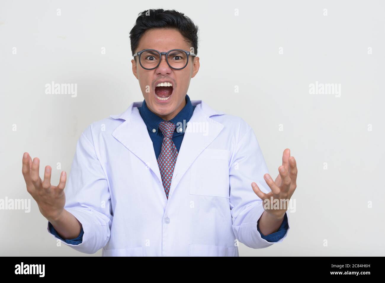 Portrait of angry Asian man doctor with eyeglasses shouting and ...