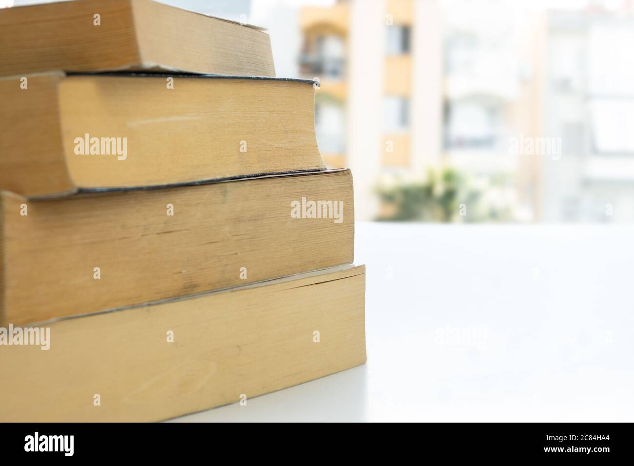 Book stack on white desk. Education background, back to school concept ...