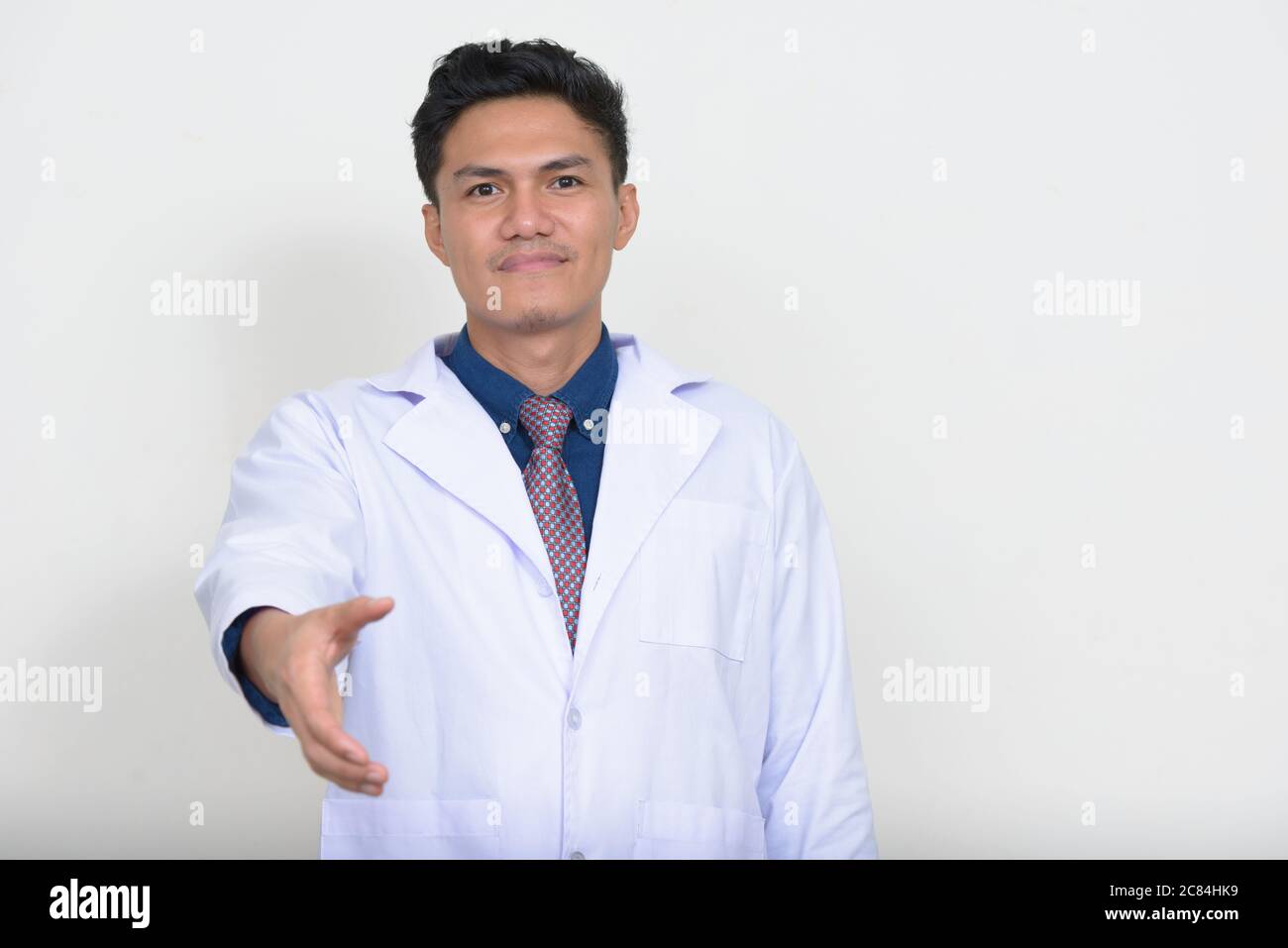 Portrait of handsome Asian man doctor giving handshake Stock Photo - Alamy